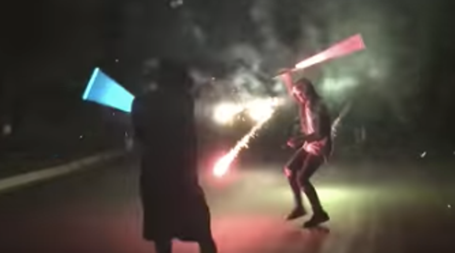 Two Folks Wield Lightsabers Against Fireworks From The Dark Side ...