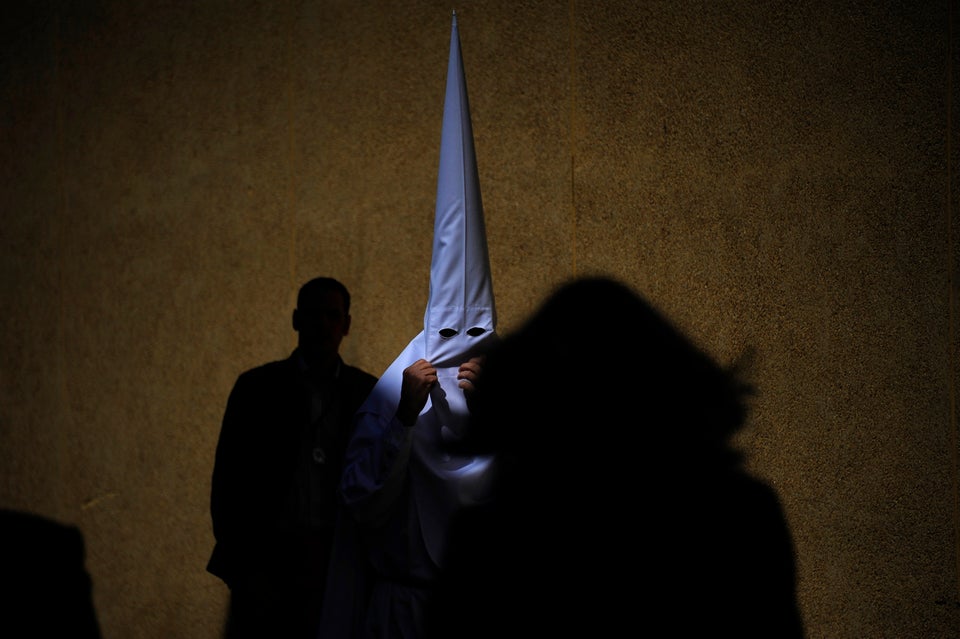 Penitents From Across Spain Carry Crosses In Holy Week Procession ...