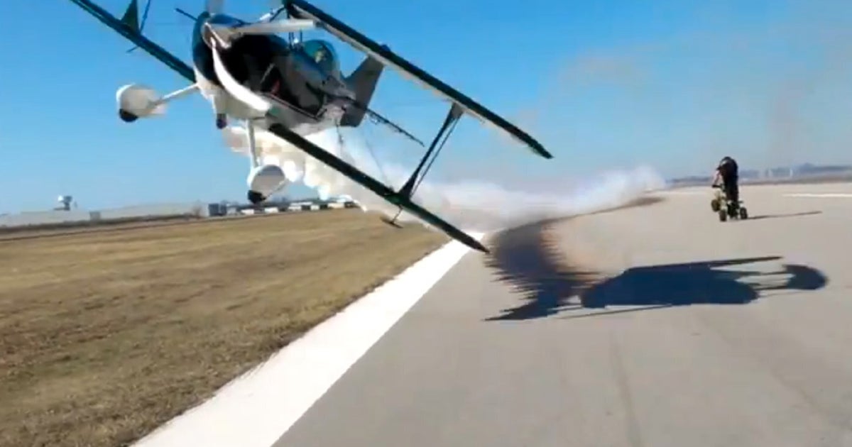 Crazy Bi-Plane Stunt Sees Aircraft Fly Within Feet Of Cameraman On ...
