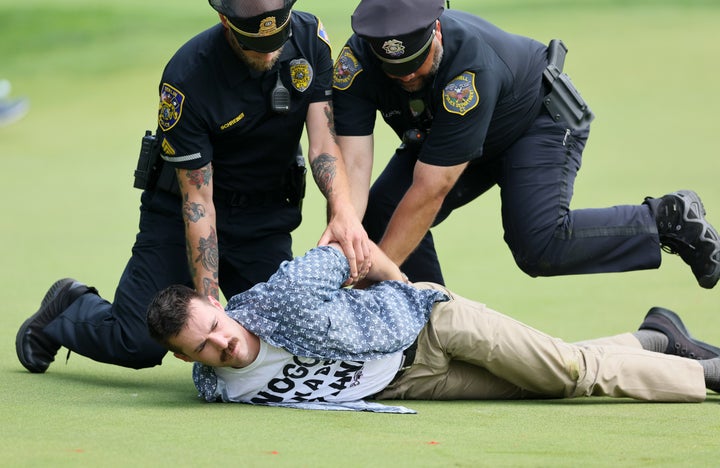 Six Climate Protesters Run Onto 18th Green And Spray Powder, Delaying ...