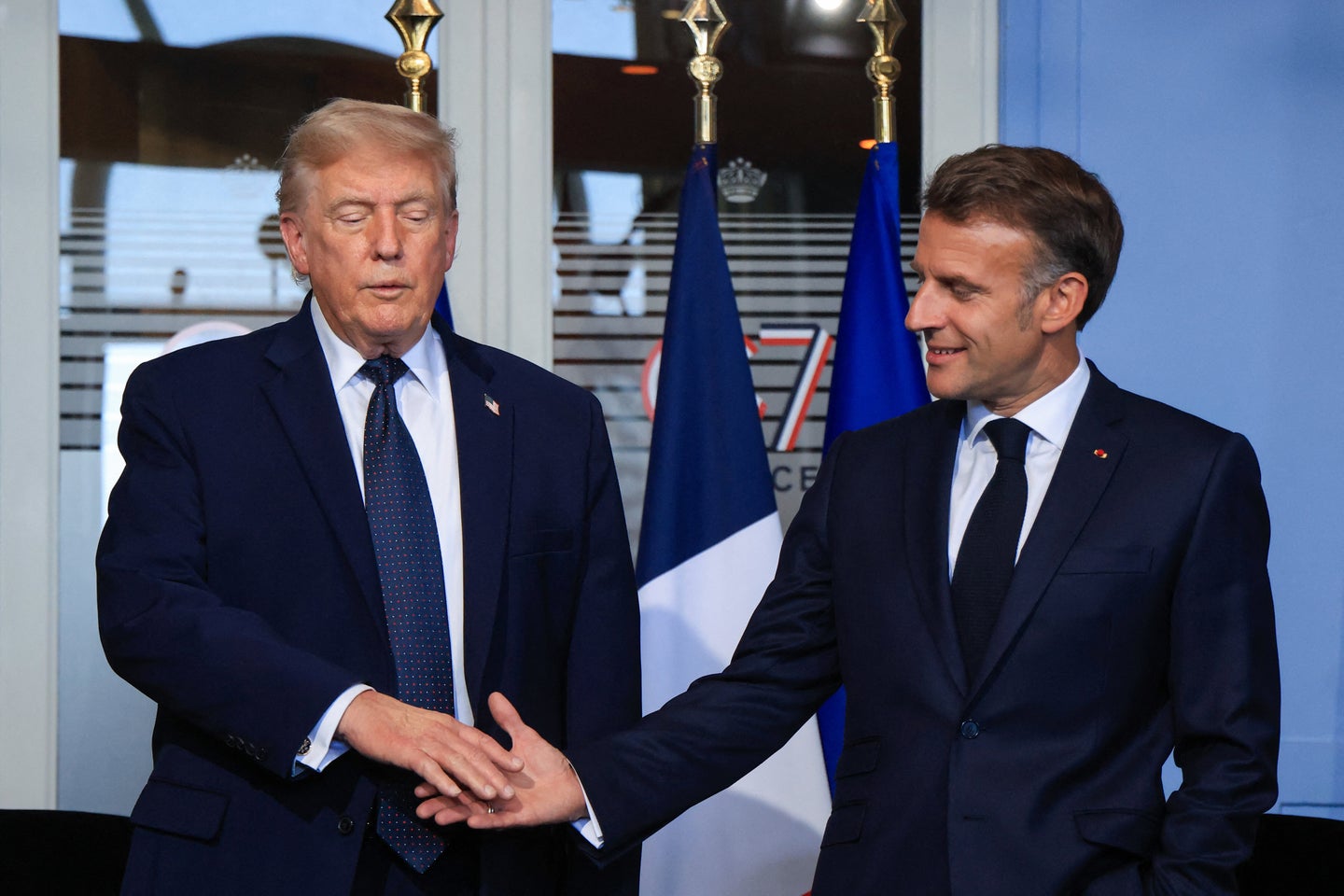 Body Language Experts Analyze Trump's Unusual Handshake With Emmanuel ...